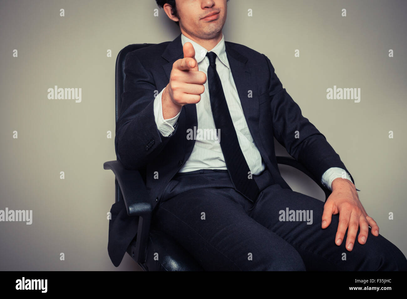 Confident young businessman is sitting in an office chair Stock Photo ...