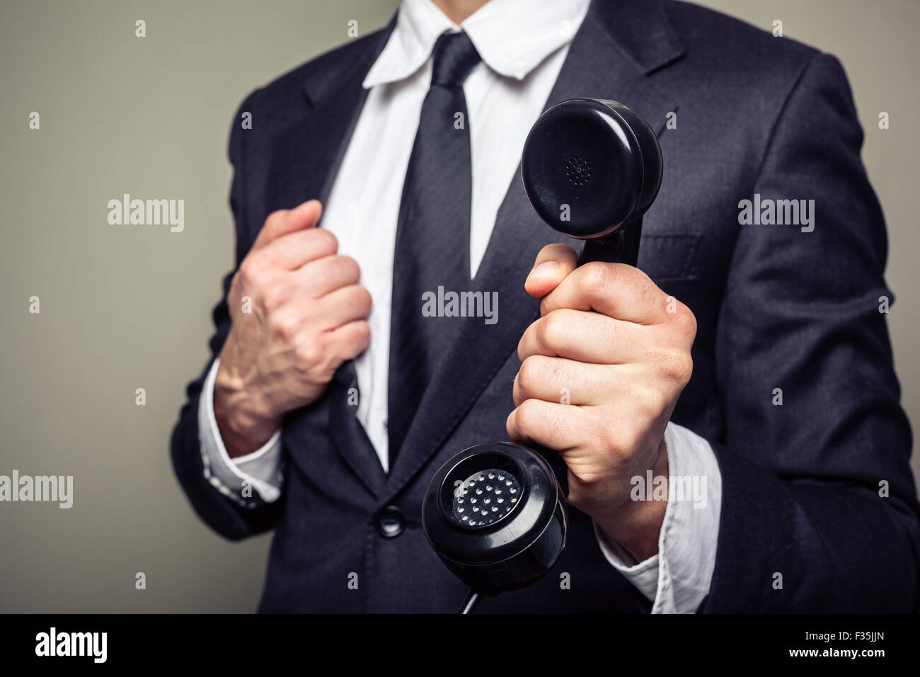 Businessman is handing over a telephone receiver Stock Photo - Alamy