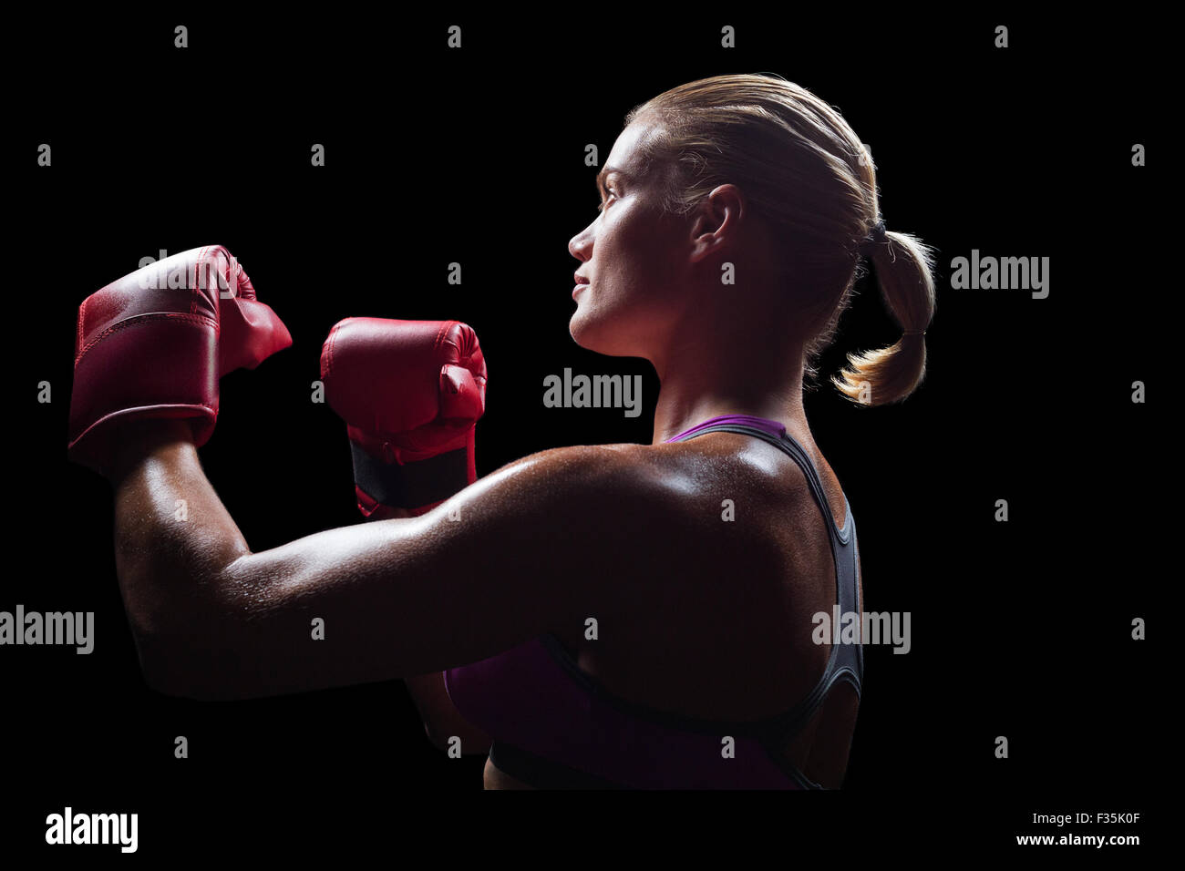 Side view of female boxer with fighting stance Stock Photo - Alamy