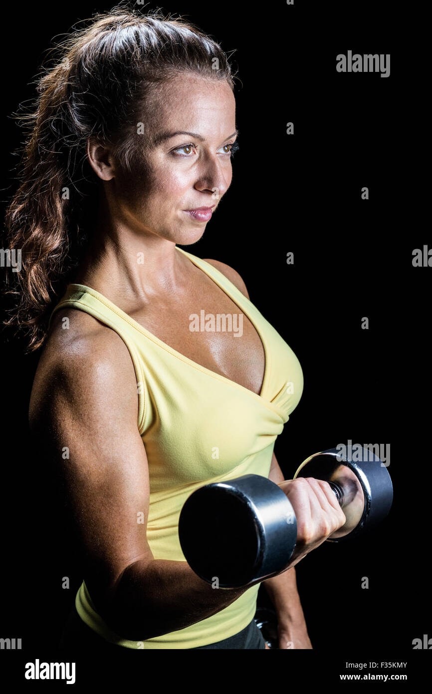 Confident pretty woman lifting dumbbells Stock Photo - Alamy