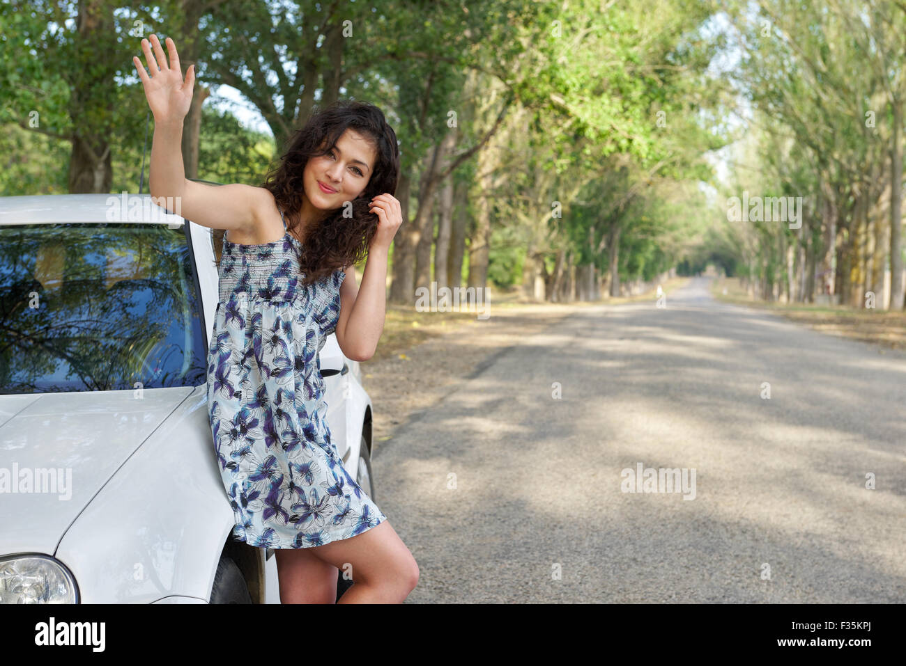 girl on road greeting gesture near white car Stock Photo - Alamy