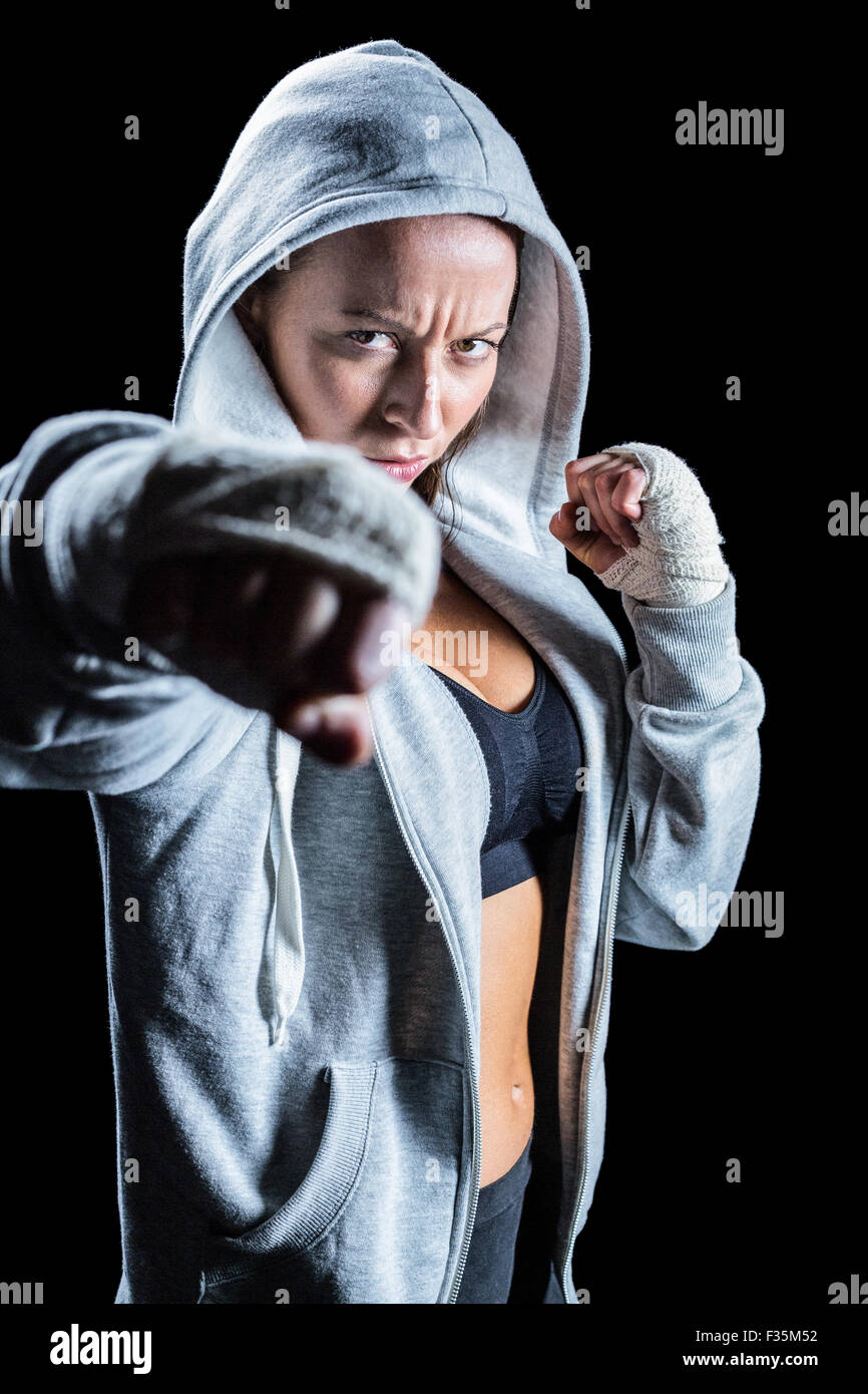 Portrait of female fighter in hood with fighting stance Stock Photo - Alamy