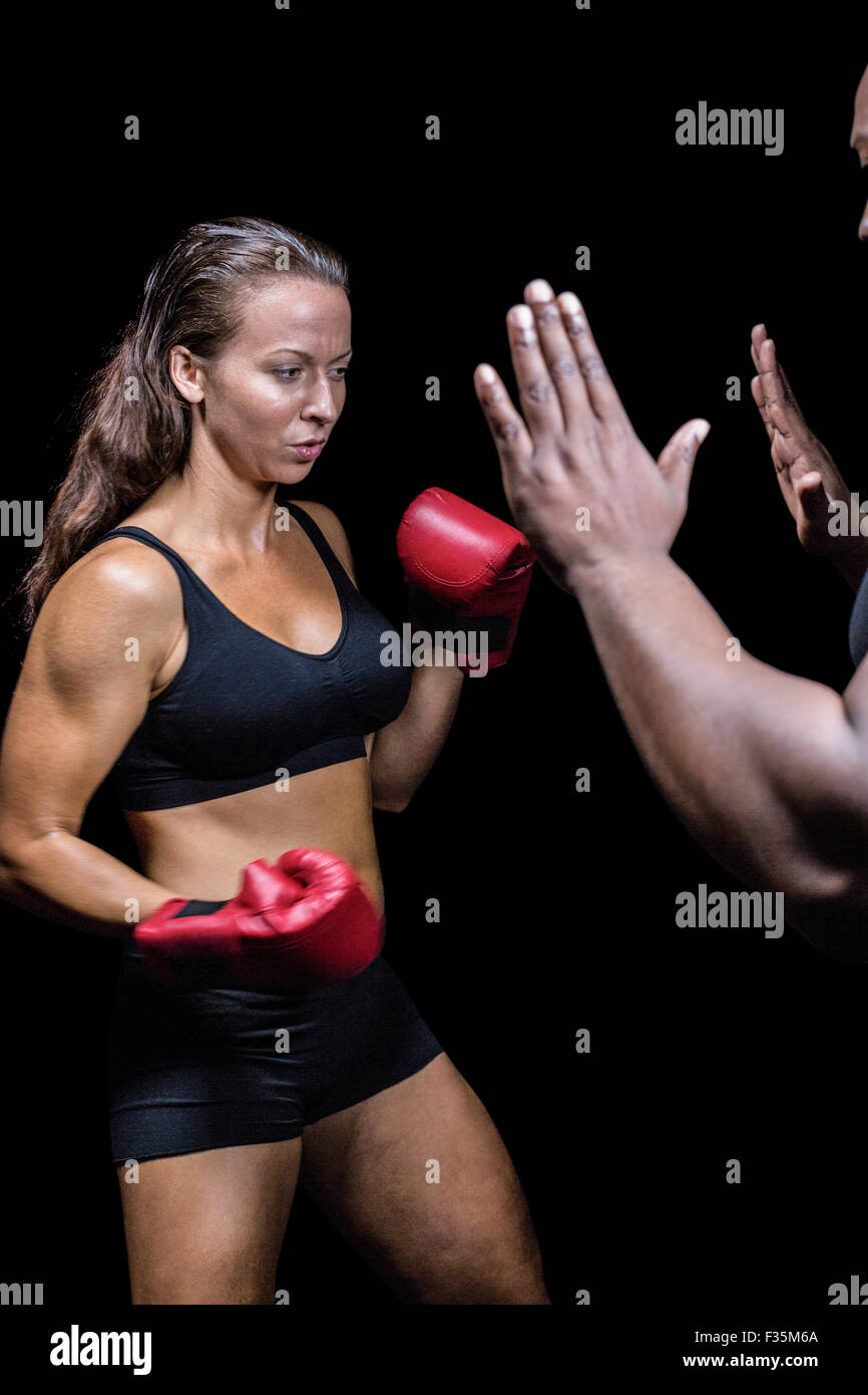 Female boxer hitting on trainer hand Stock Photo - Alamy