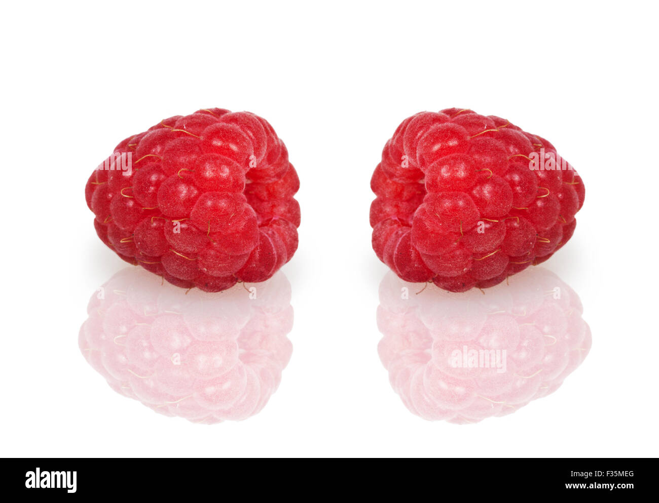 Two fresh red raspberries isolated on white background Stock Photo - Alamy