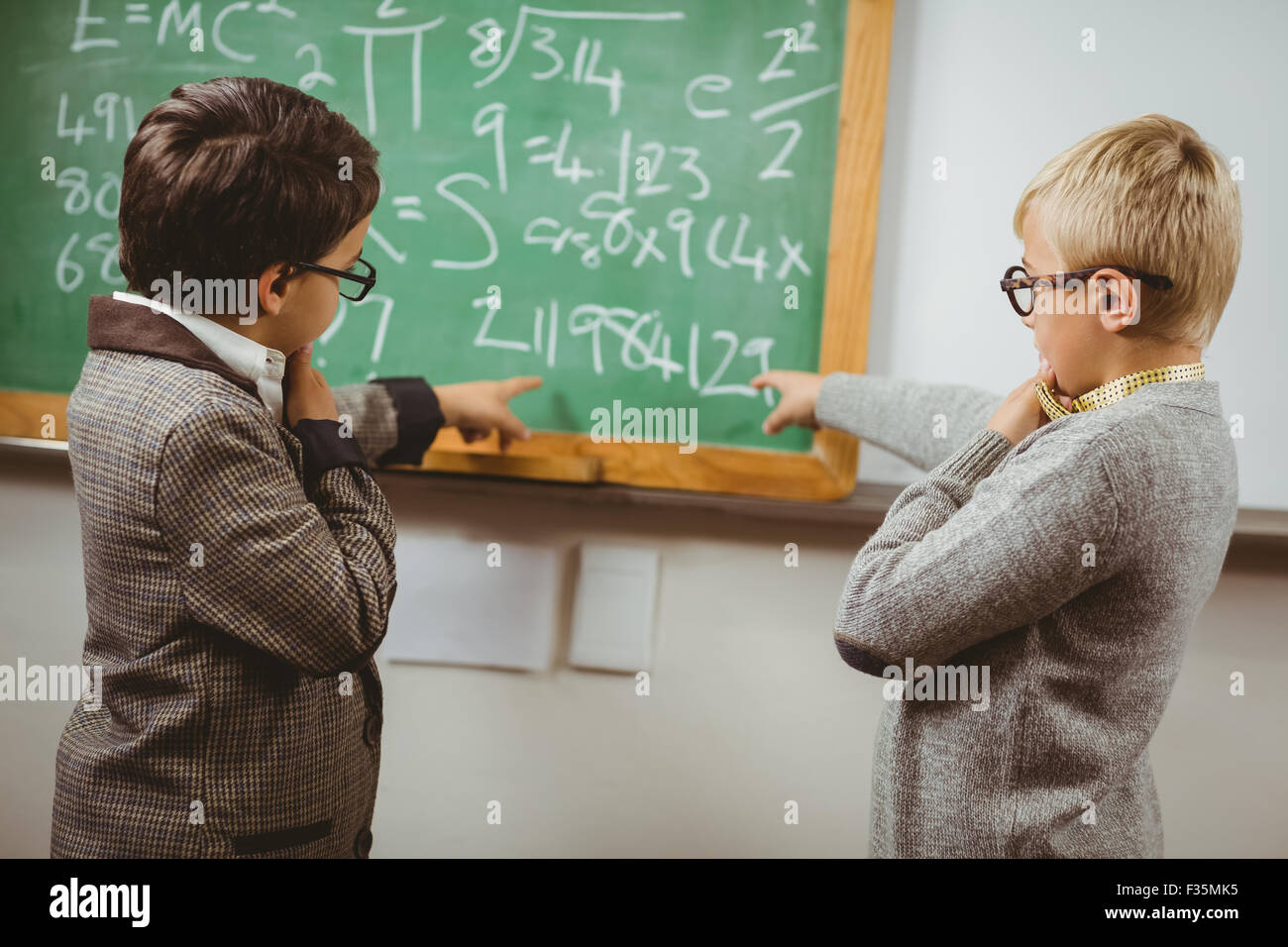 Pupils dressed up as teachers discussing in a classroom Stock Photo - Alamy