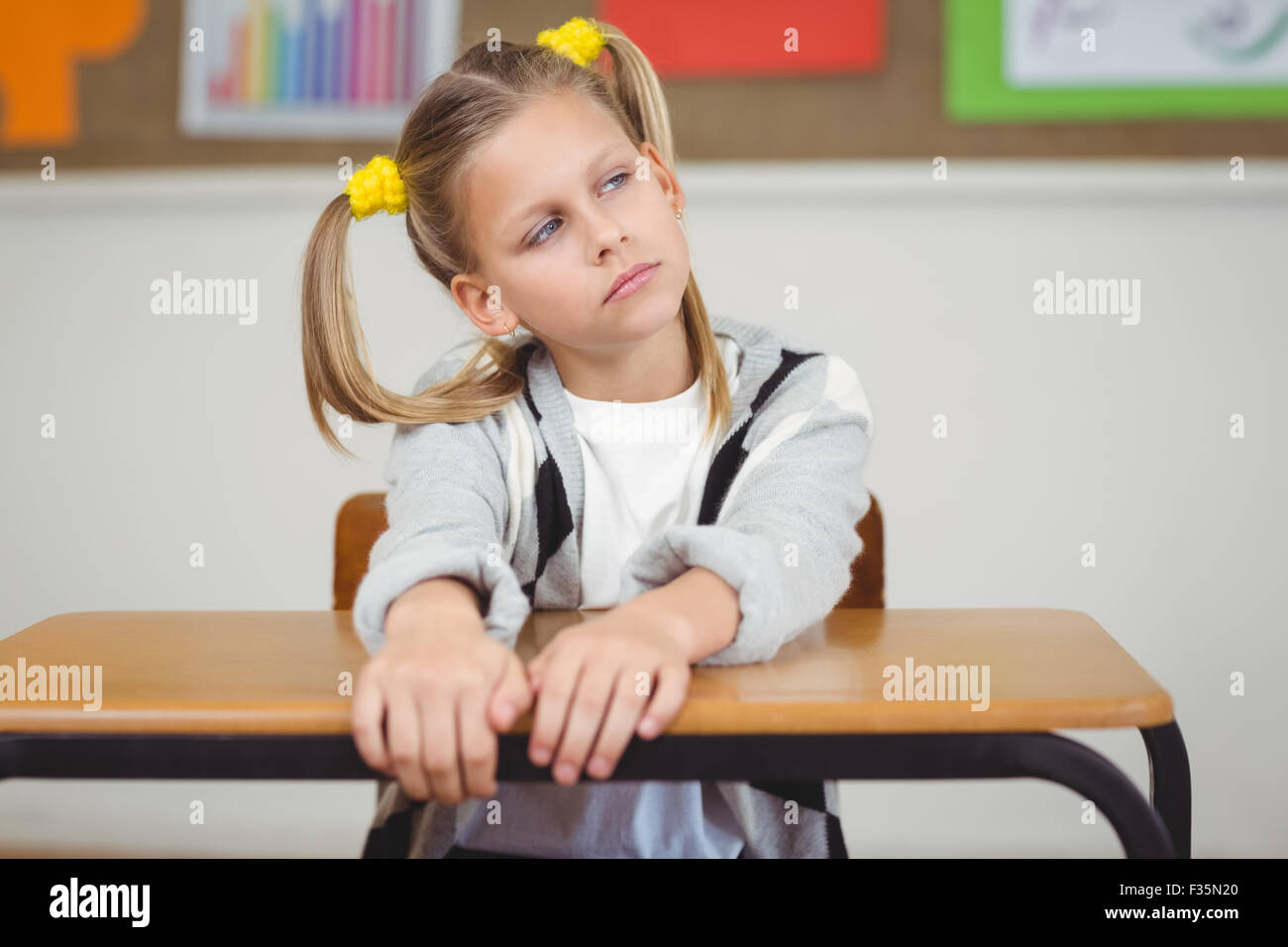 Thoughtful pupil sitting at her desk in a classroom Stock Photo - Alamy