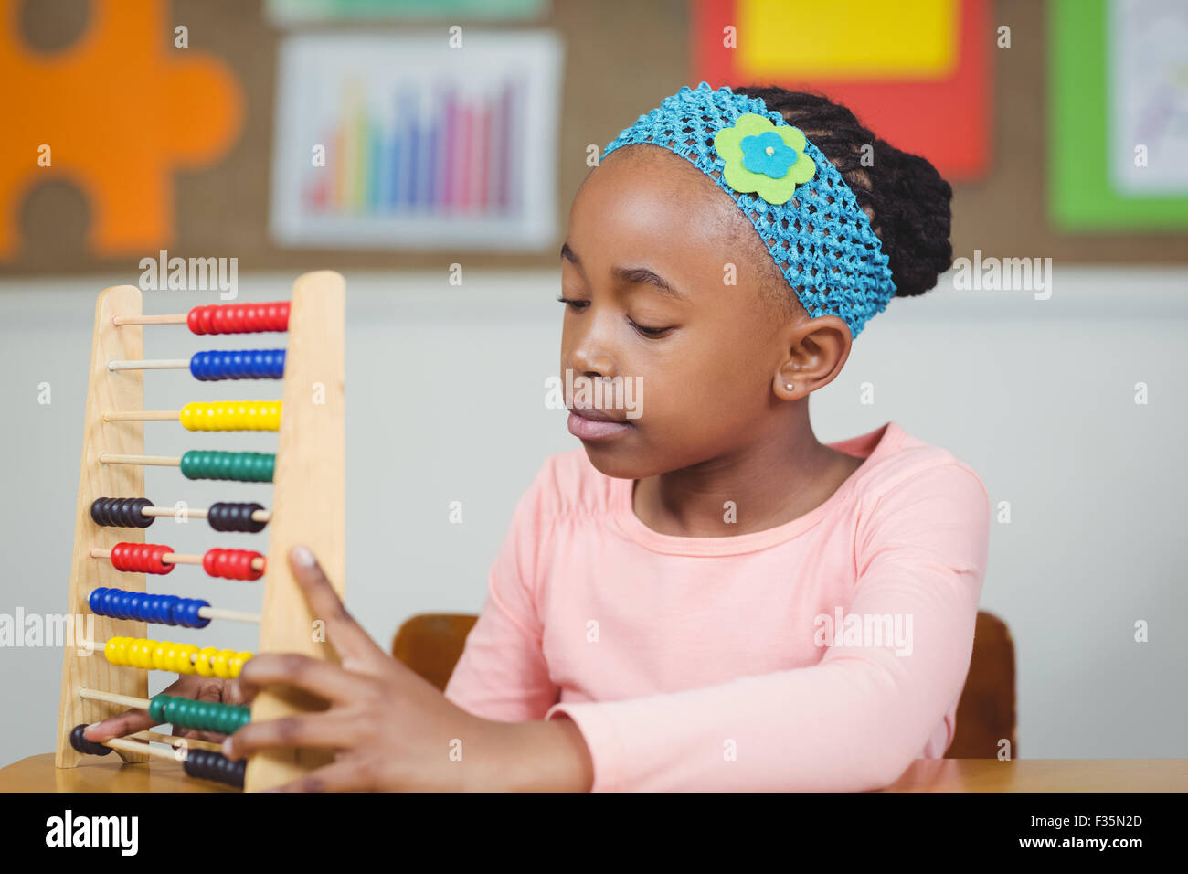Focused pupil calculating with abacus in a classroom Stock Photo - Alamy