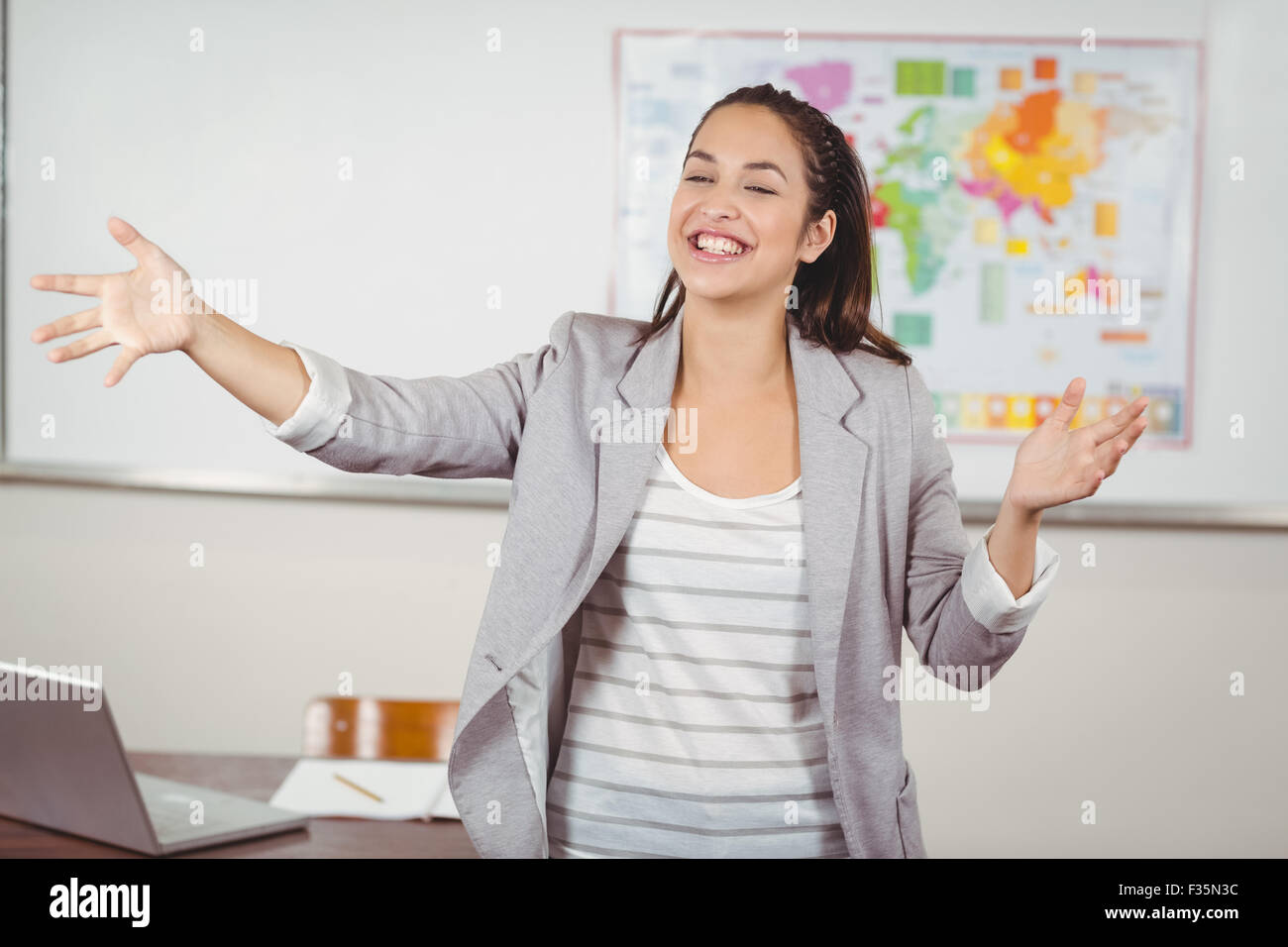 Pretty teacher teaching in a classroom Stock Photo - Alamy
