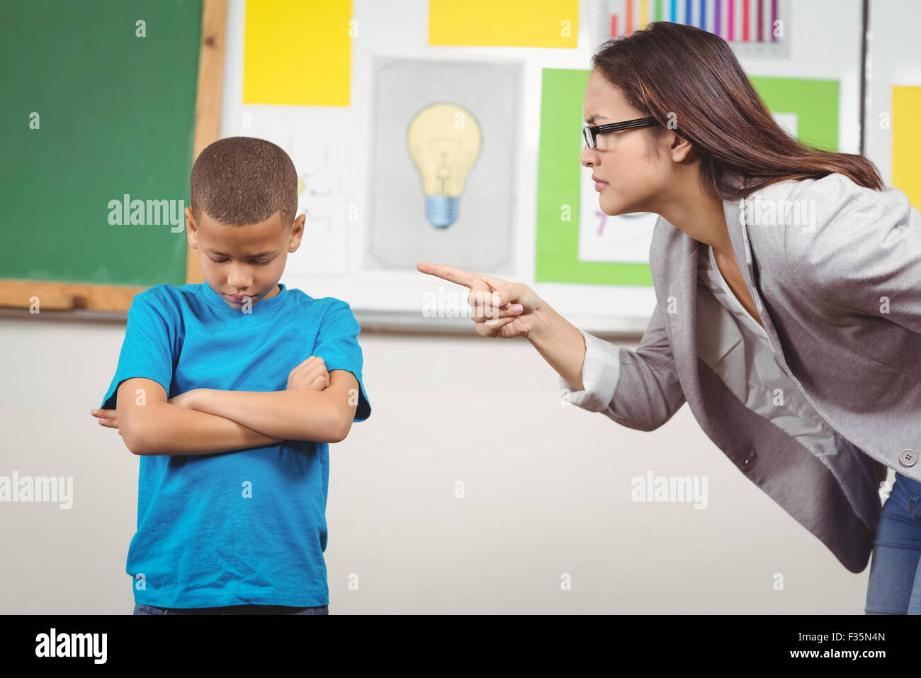 Pretty teacher reprimanding a pupil Stock Photo - Alamy
