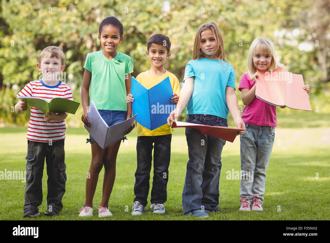 Smiling classmates holding notepads Stock Photo - Alamy