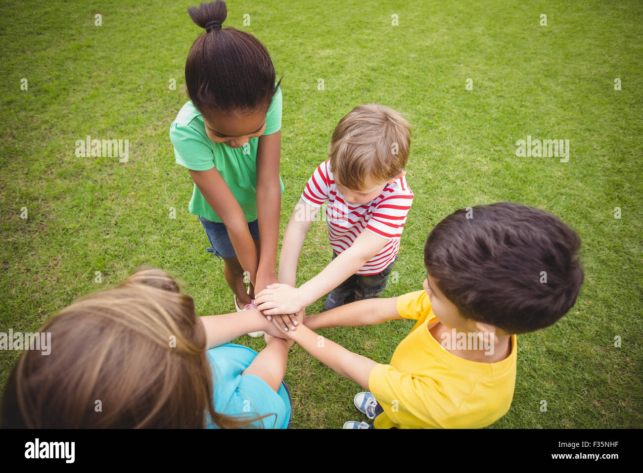 Diverse classmates putting hands together Stock Photo - Alamy