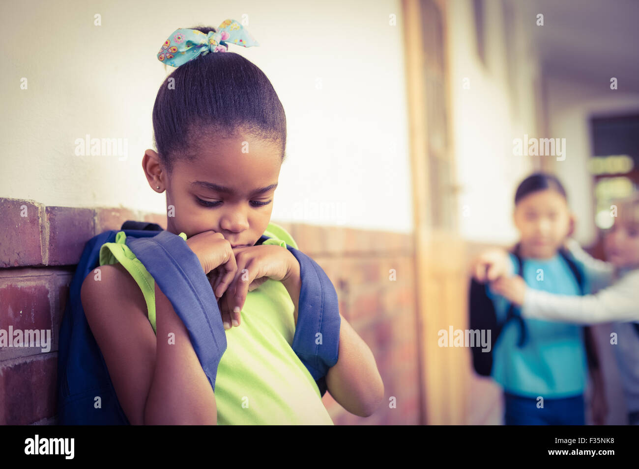 Sad pupil being bullied by classmates at corridor Stock Photo - Alamy