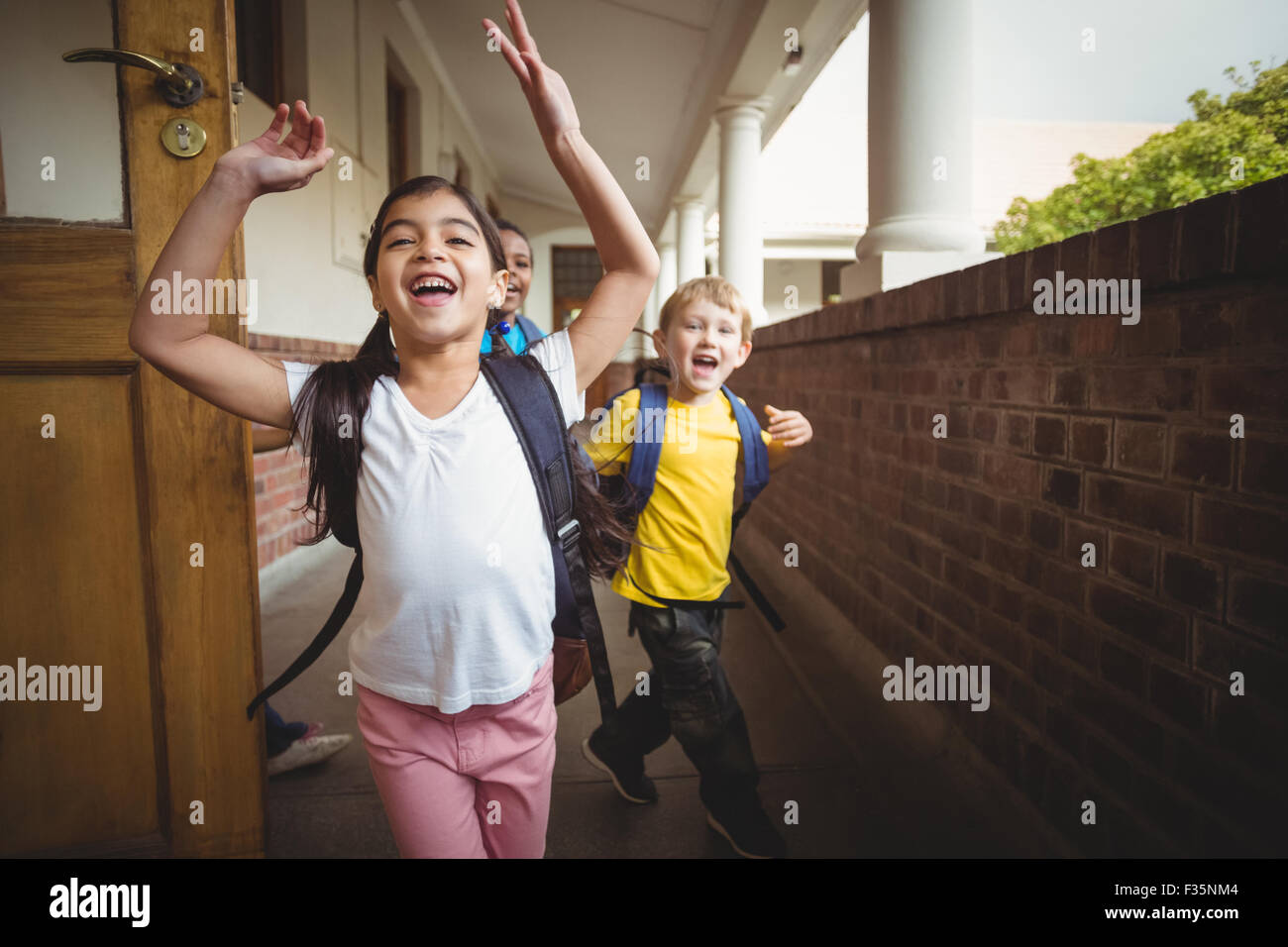 Happy pupils leaving the classroom Stock Photo - Alamy