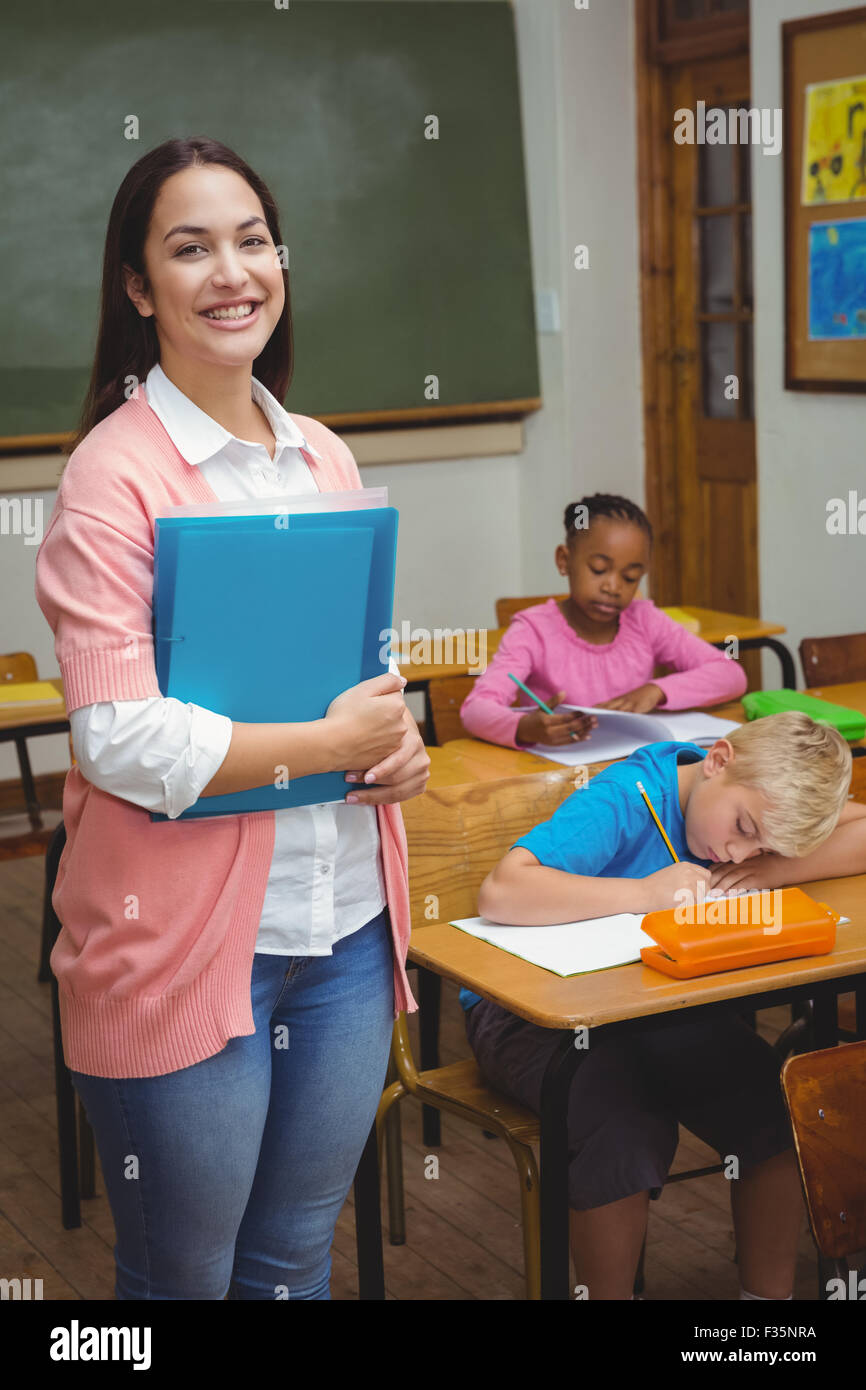 Teacher standing by her students Stock Photo - Alamy