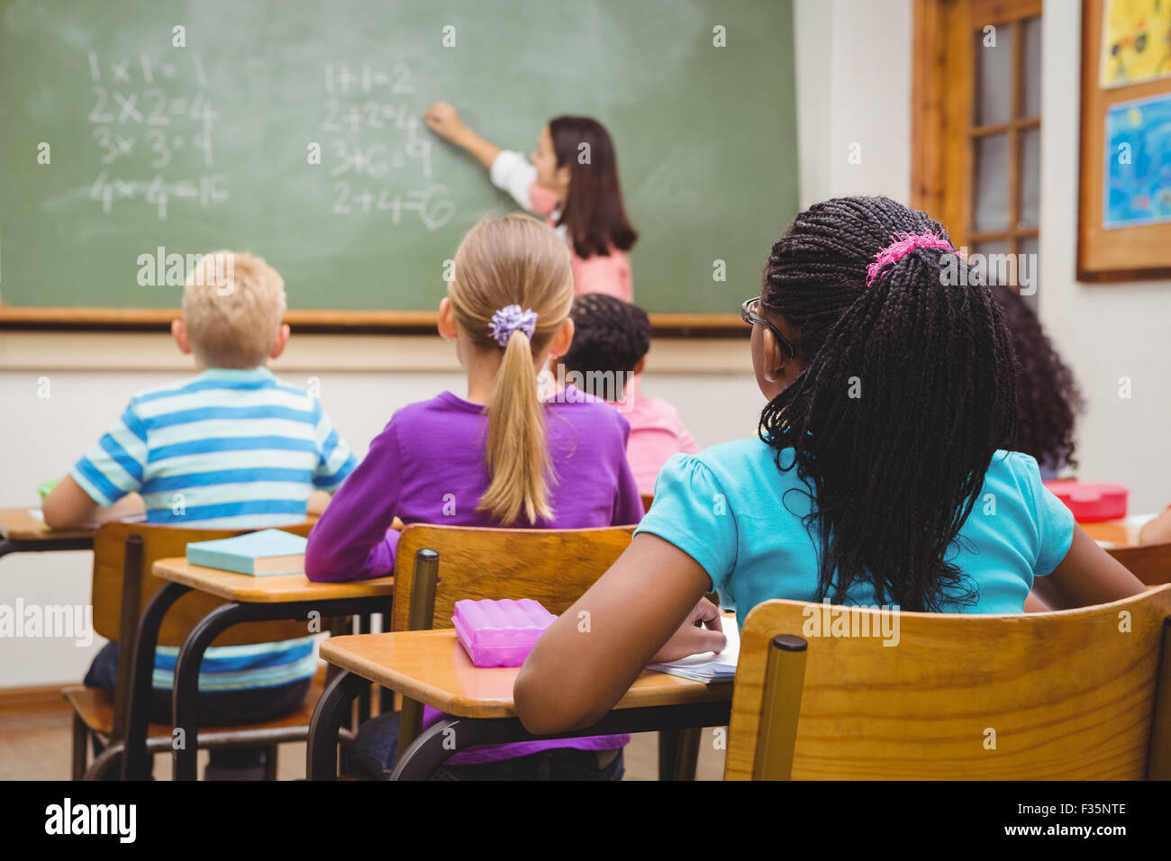 Teacher writing on the blackboard Stock Photo - Alamy