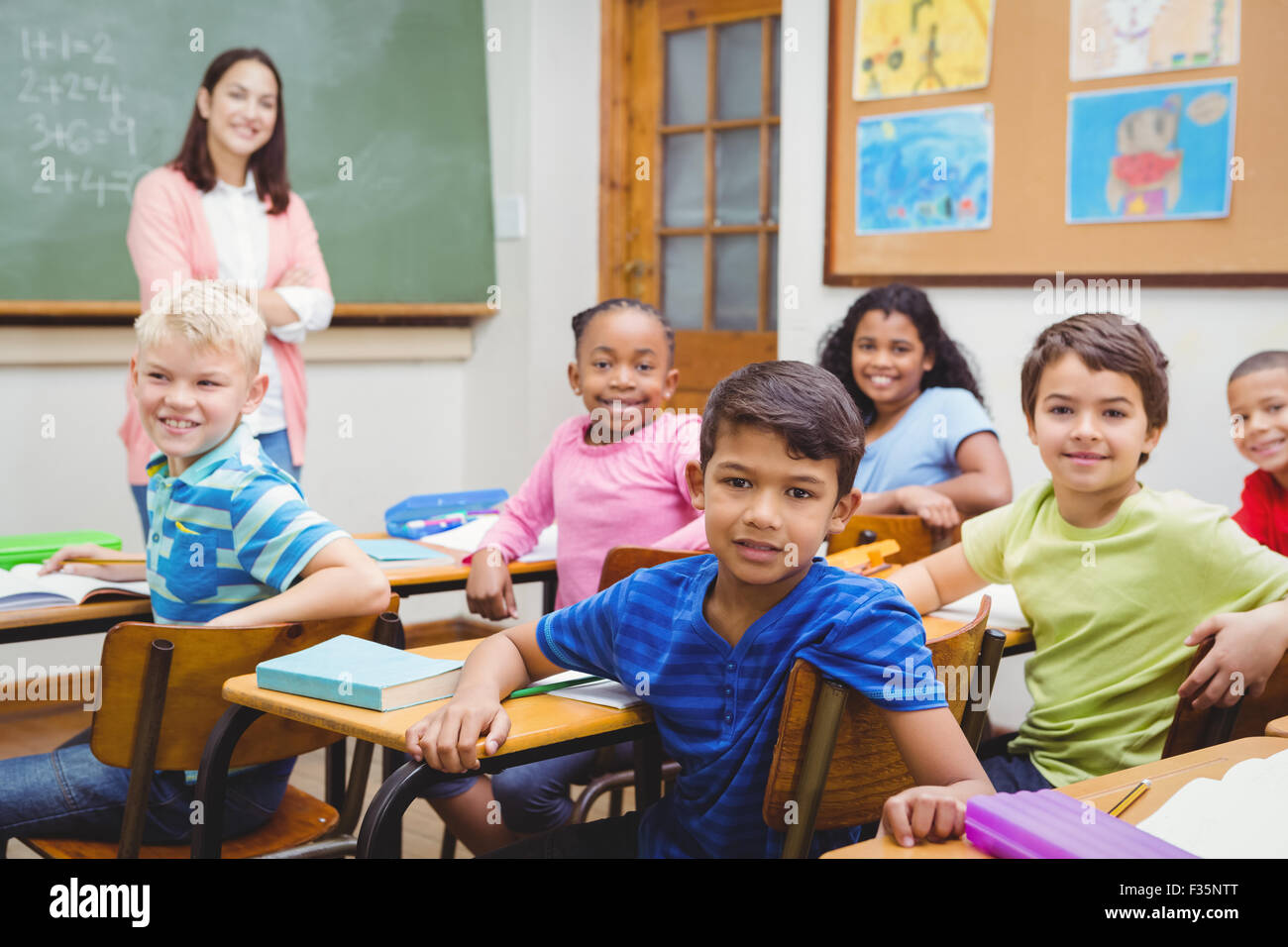 Students and teacher looking at the camera Stock Photo - Alamy