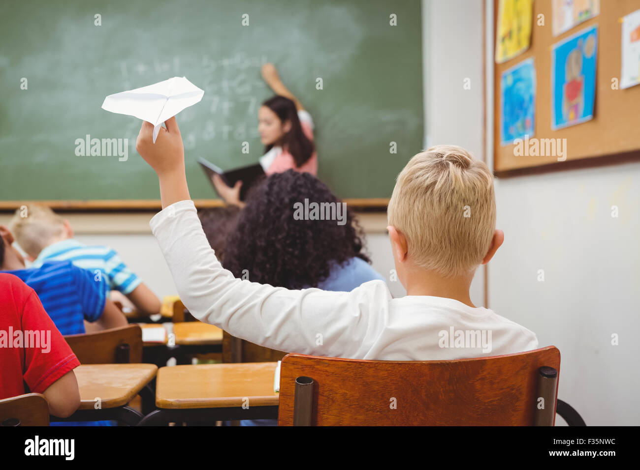 Student about to throw a paper airplane Stock Photo - Alamy