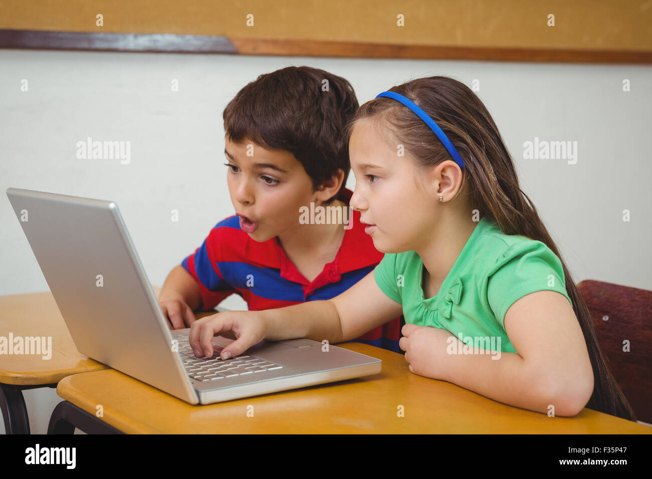 Pupils using a laptop in class Stock Photo - Alamy