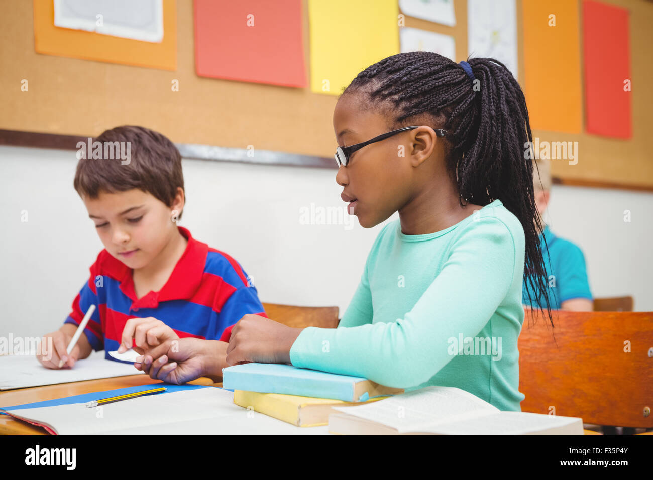 Student helping fellow student in class Stock Photo - Alamy