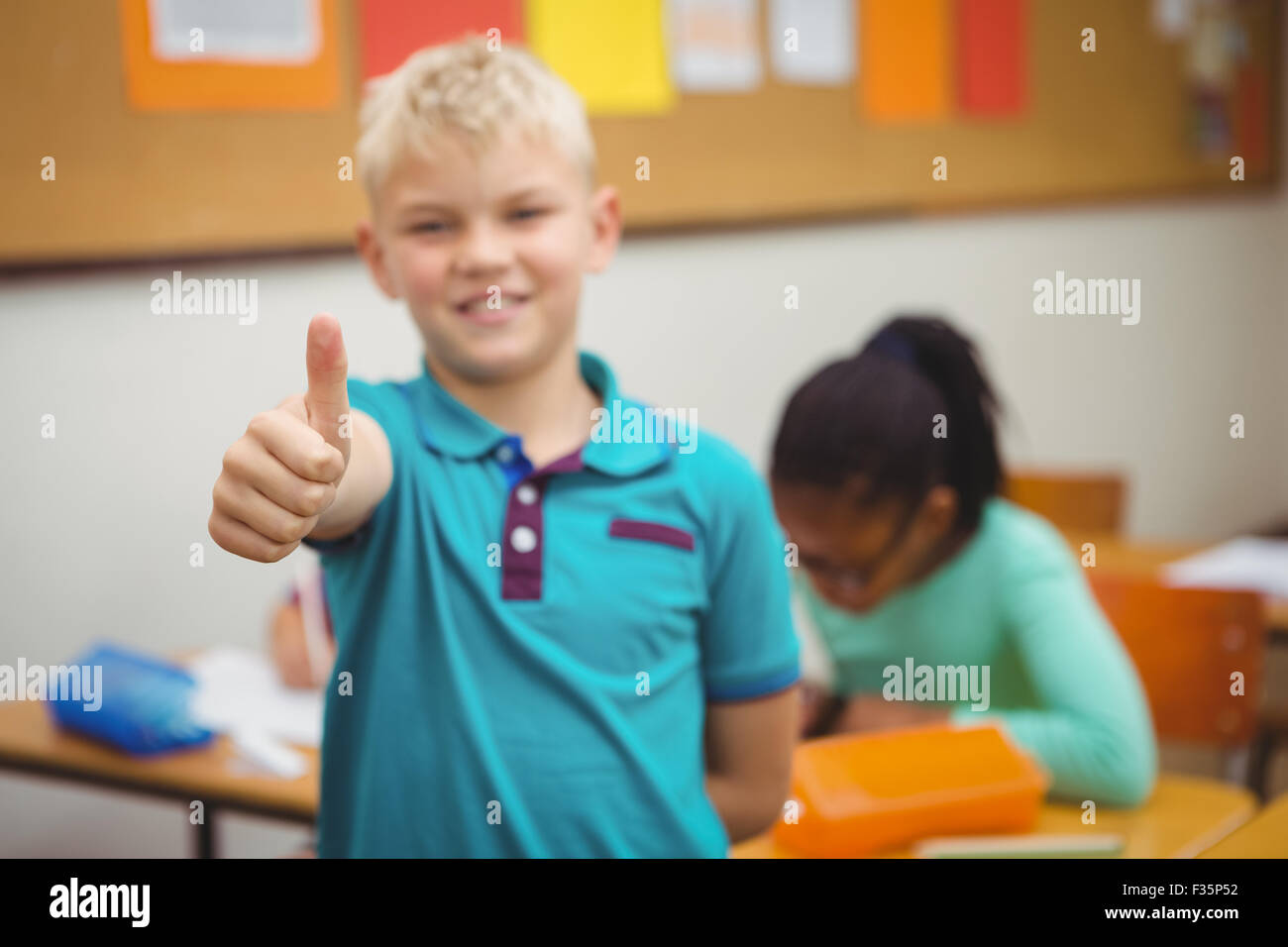 Smiling student with thumbs up Stock Photo - Alamy
