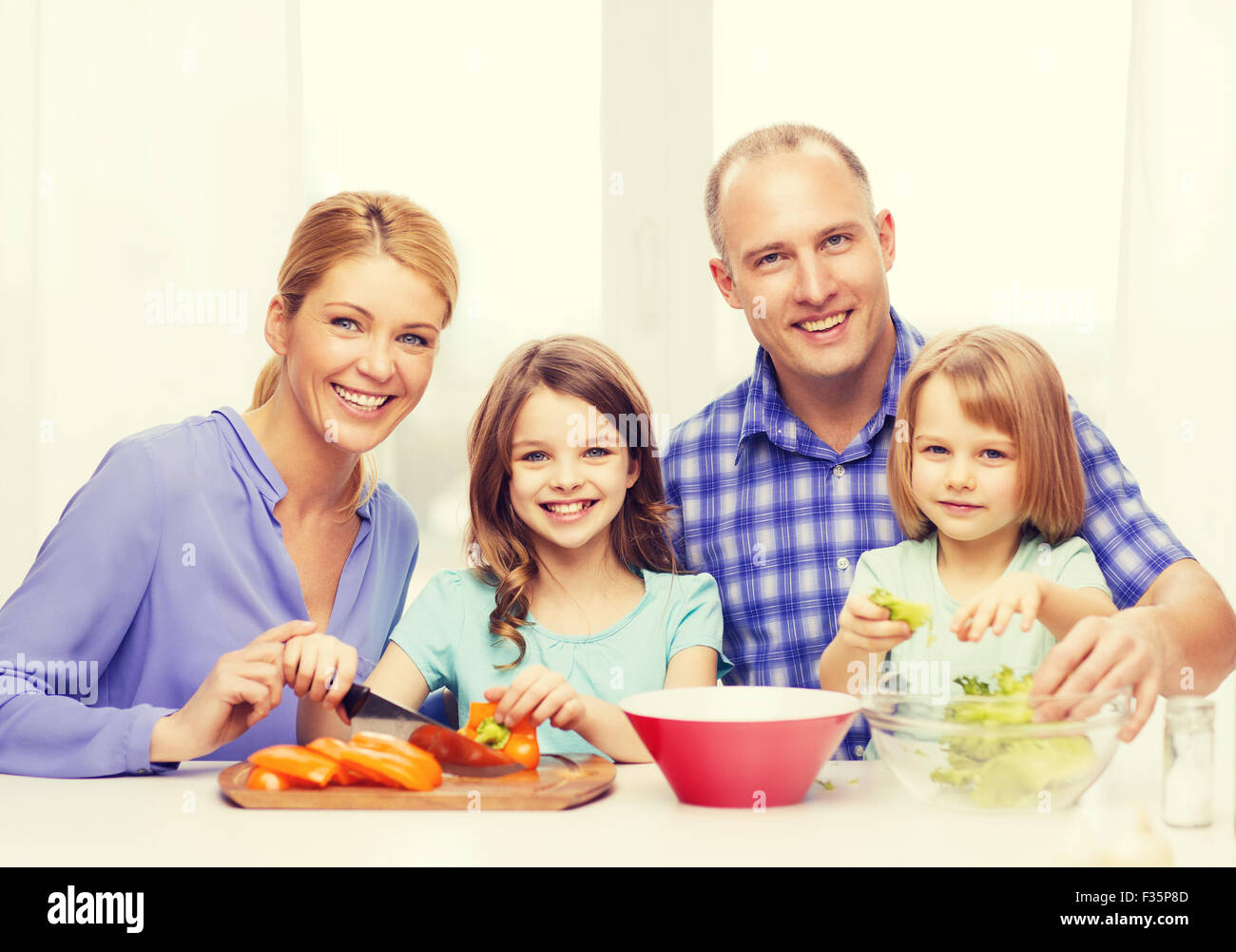 happy family with two kids making dinner at home Stock Photo - Alamy