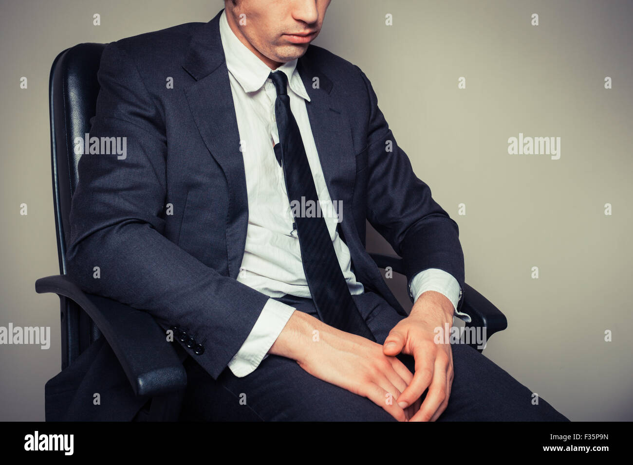 Sad and tired businessman is sitting in an office chair Stock Photo - Alamy