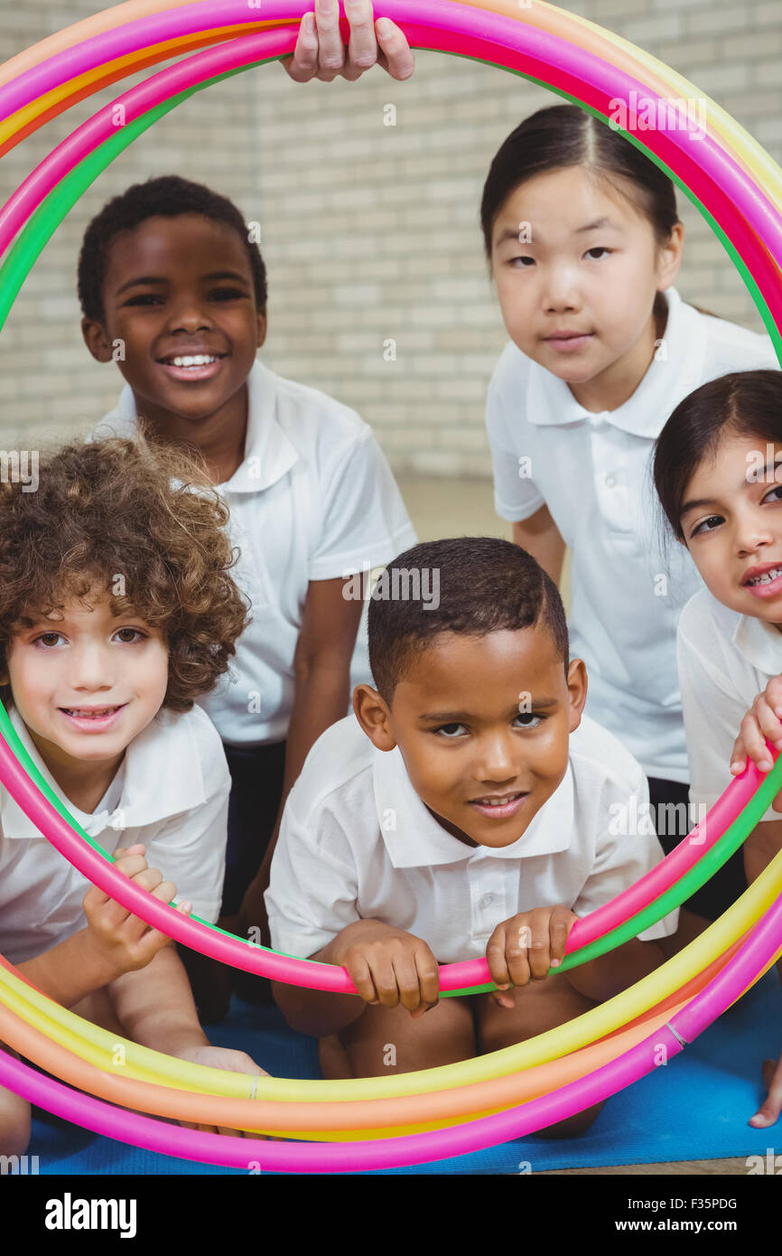 Students looking through hula hoops Stock Photo - Alamy
