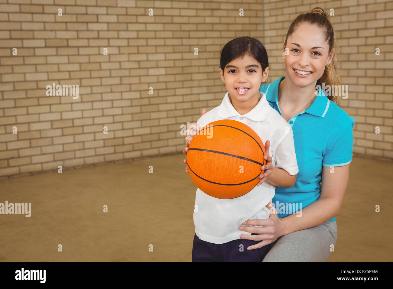 Student holding basketball with teacher Stock Photo - Alamy
