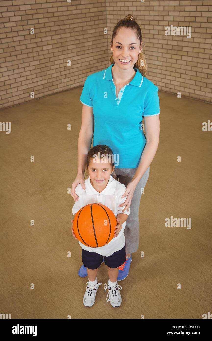 Student holding basketball with teacher Stock Photo - Alamy