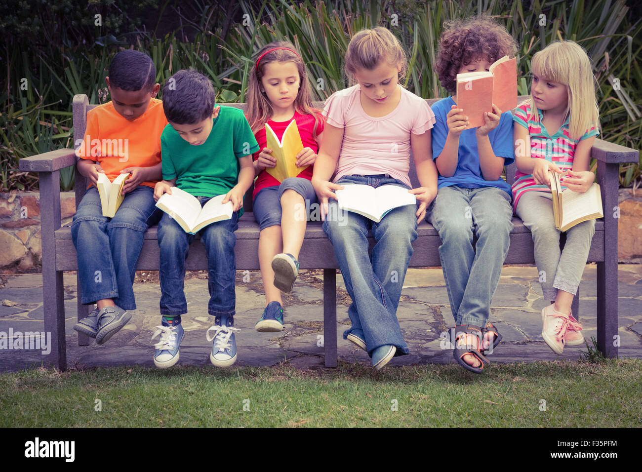 Children reading from books together Stock Photo - Alamy