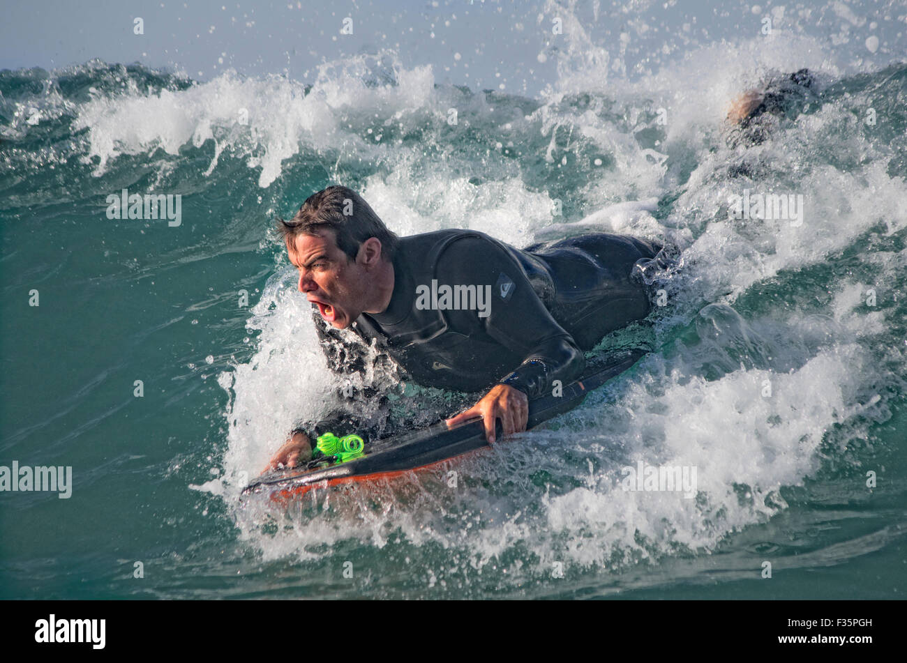 Bodyboarder rides a wave Stock Photo - Alamy