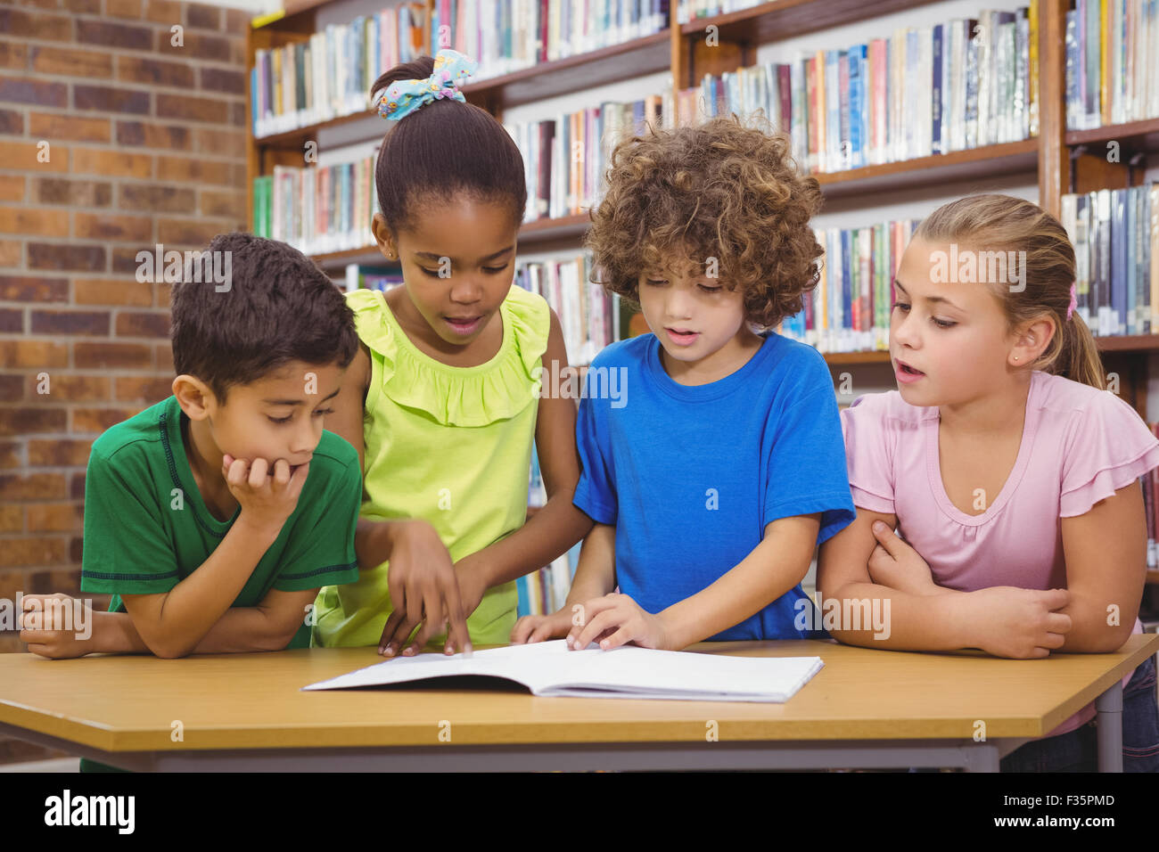 Students reading froma school book Stock Photo - Alamy
