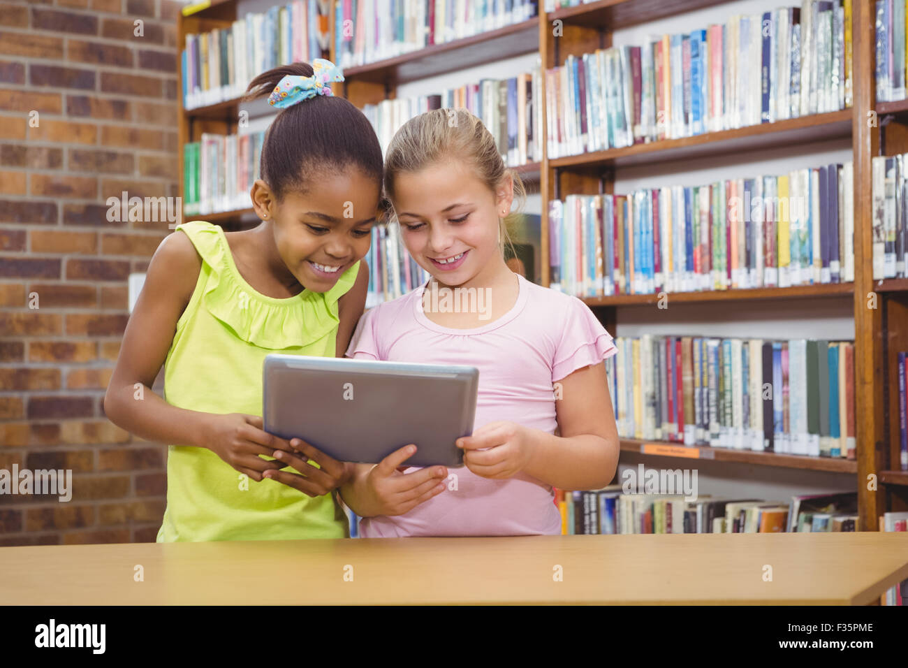 Students using a tablet pc together Stock Photo - Alamy