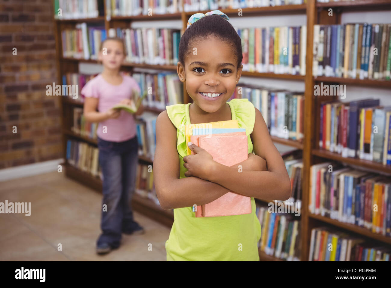 Smiling student holding a few books Stock Photo - Alamy