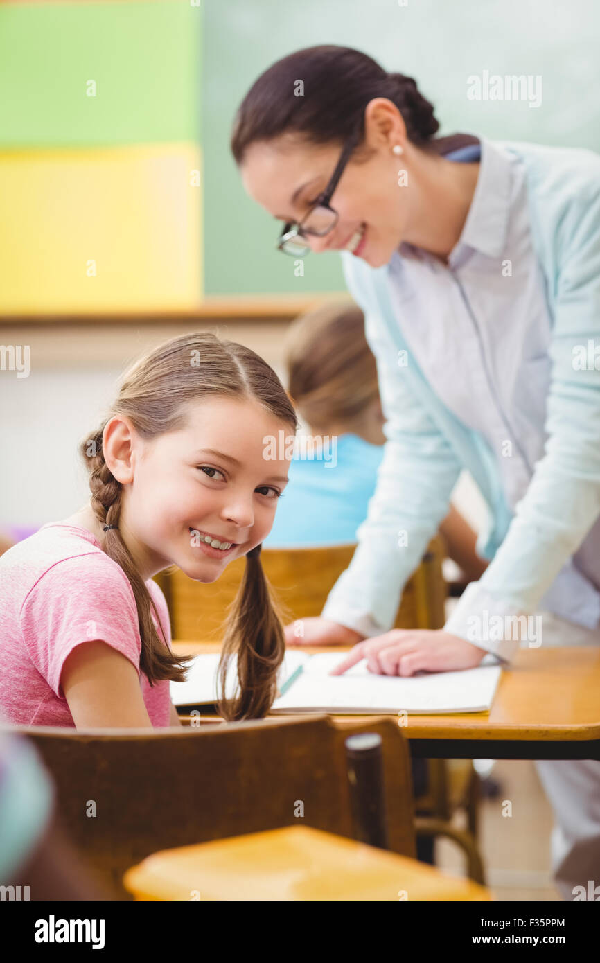 Teacher helping a pupil during class Stock Photo - Alamy