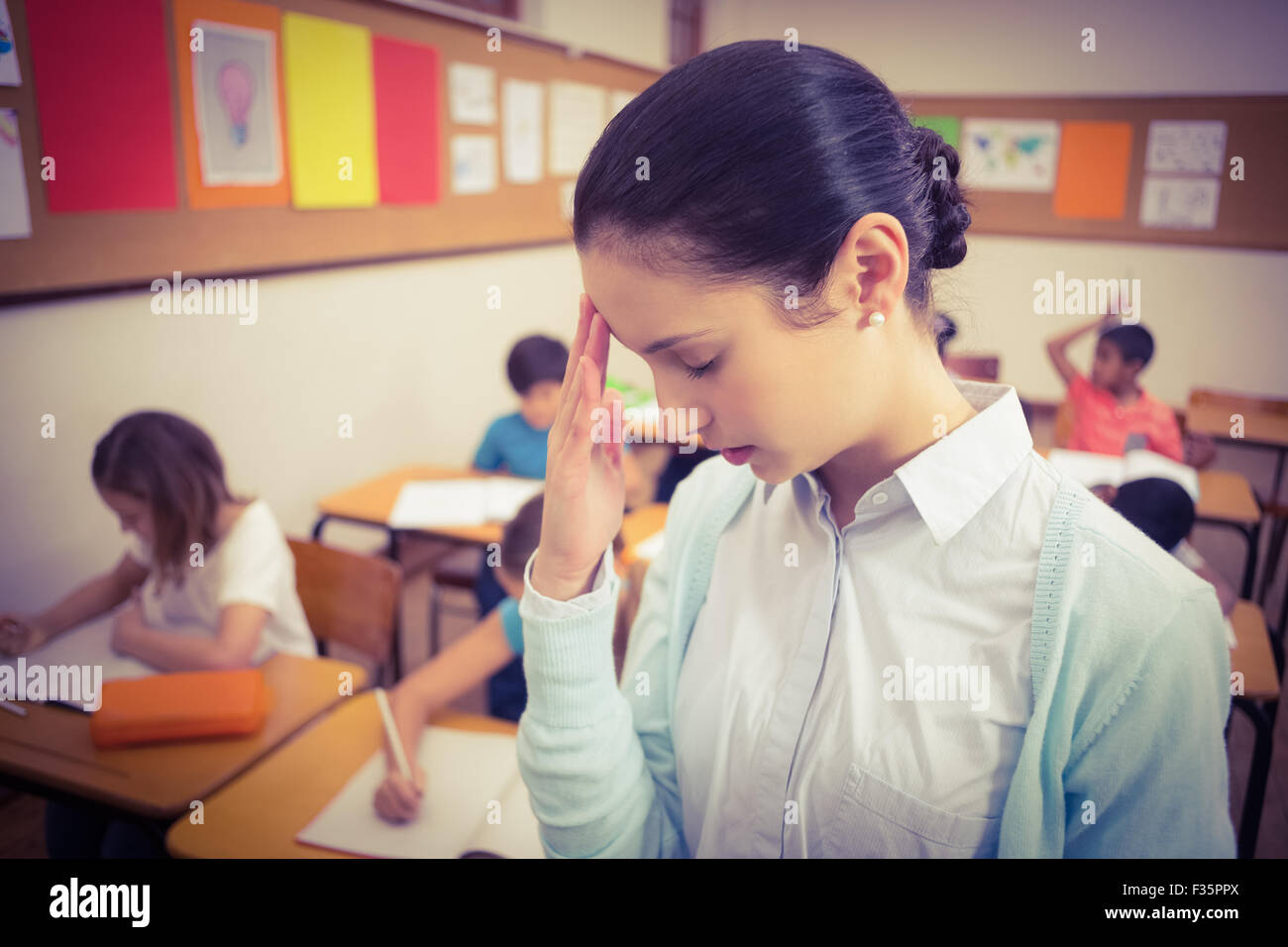 Teacher getting a headache in class Stock Photo - Alamy