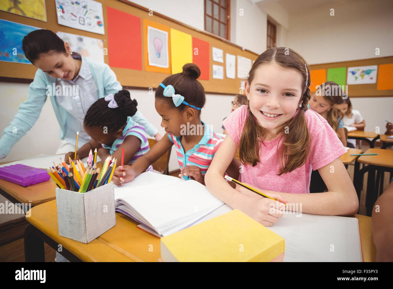 Pupils working at their desks in class Stock Photo - Alamy