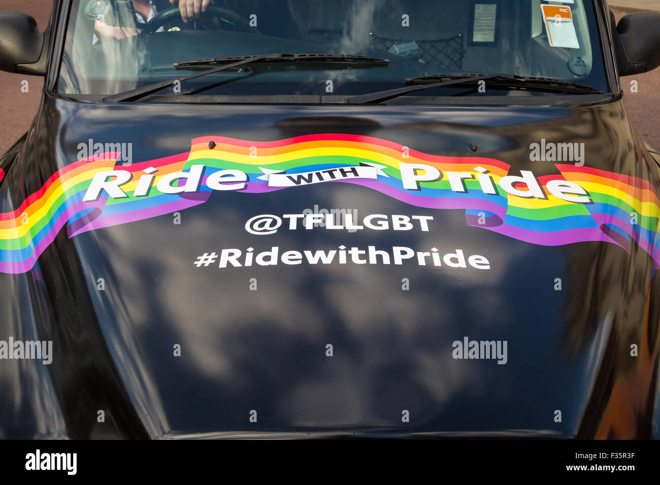 A London Black Cab, decorated with the Ride with Pride wrap Stock Photo ...