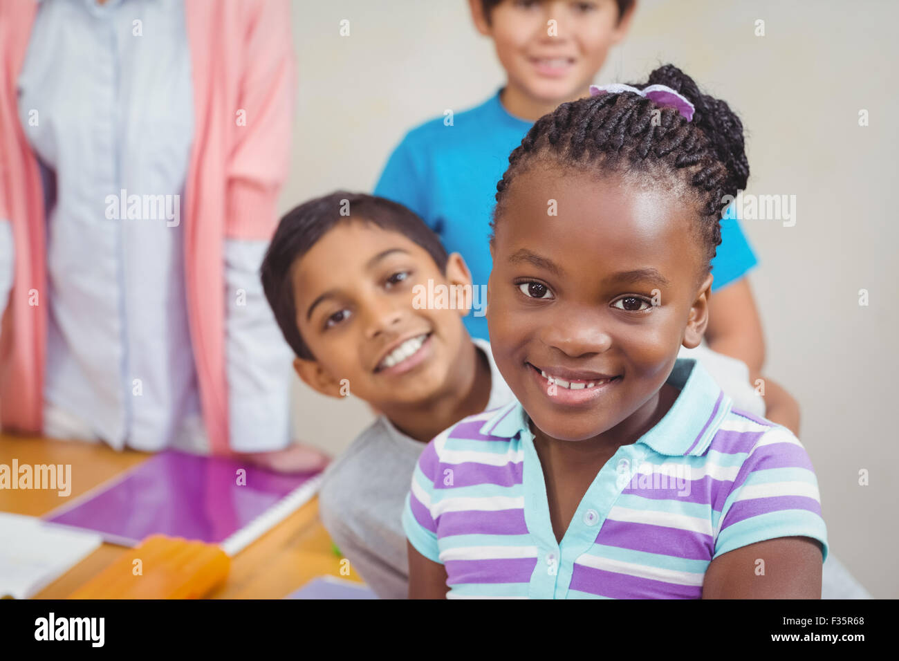 Pupils working at desk together Stock Photo - Alamy
