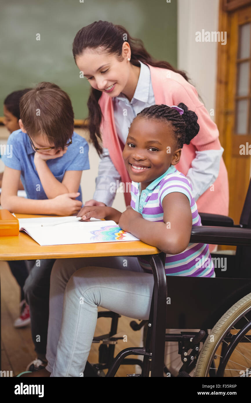 Disabled pupil smiling at camera in classroom Stock Photo - Alamy