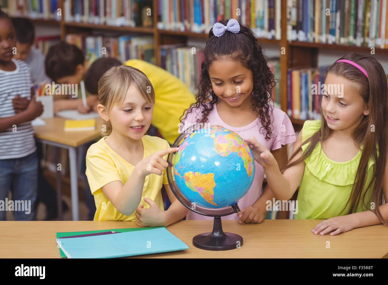 Pupils pointing globe hi-res stock photography and images - Alamy