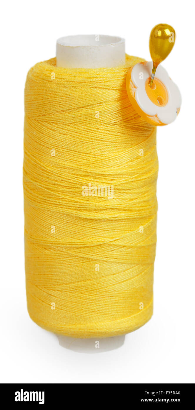 The coil of yellow thread with the yellow button on pin isolated on ...