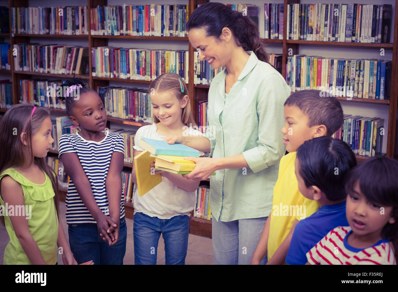 Pupils and teacher in the library Stock Photo - Alamy