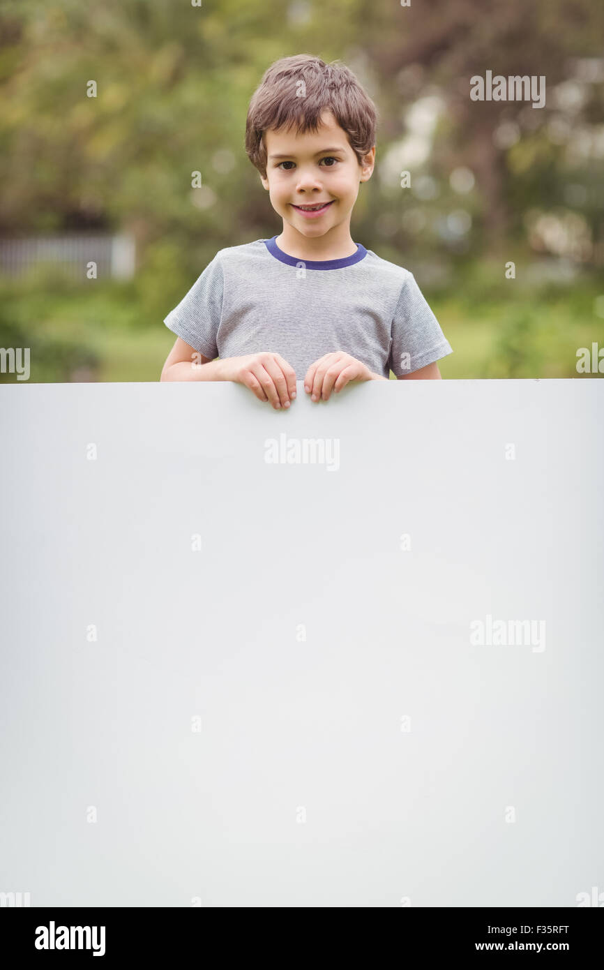 Cute pupil showing large poster Stock Photo - Alamy