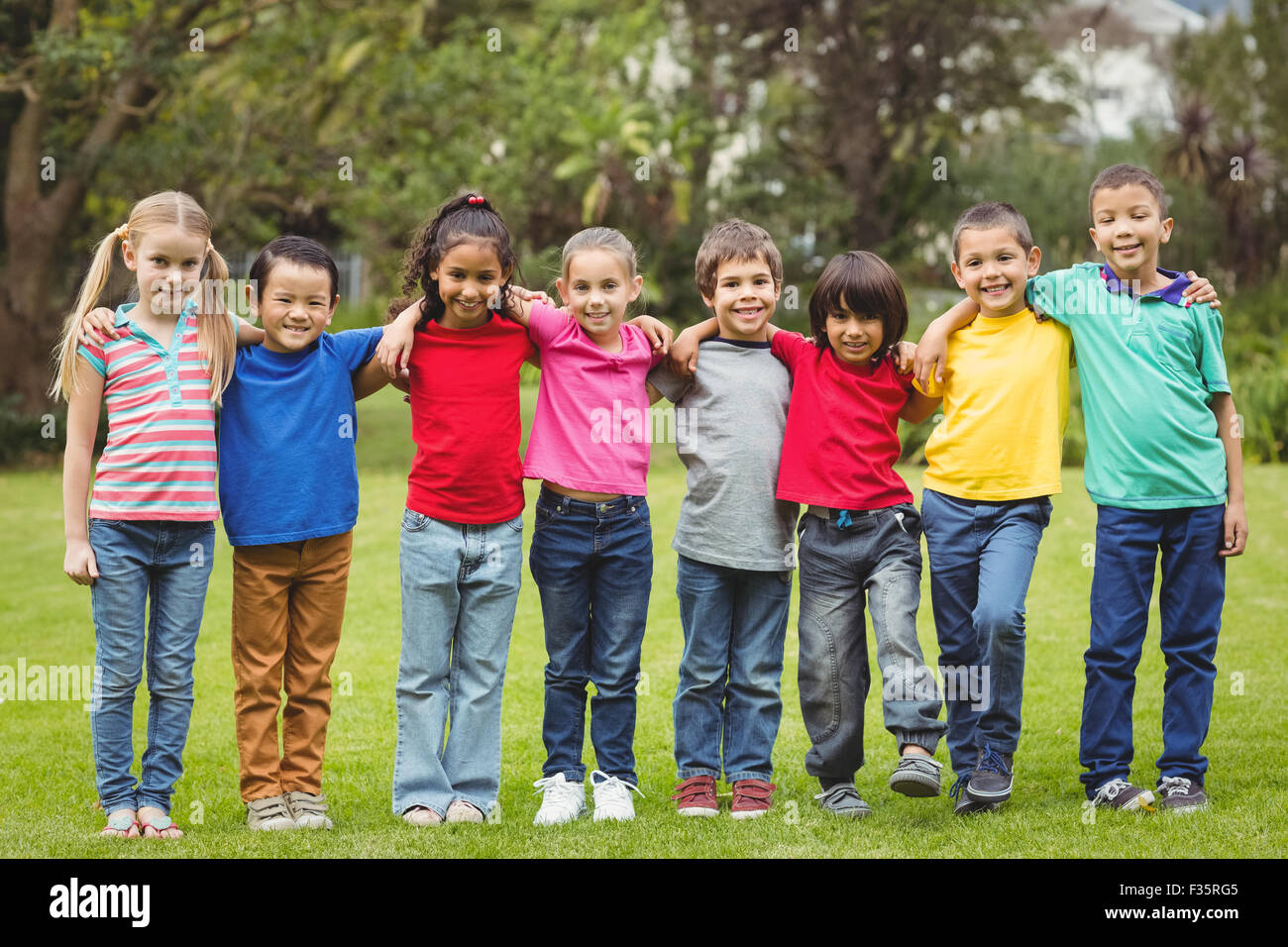 Cute pupils smiling at camera outside Stock Photo - Alamy