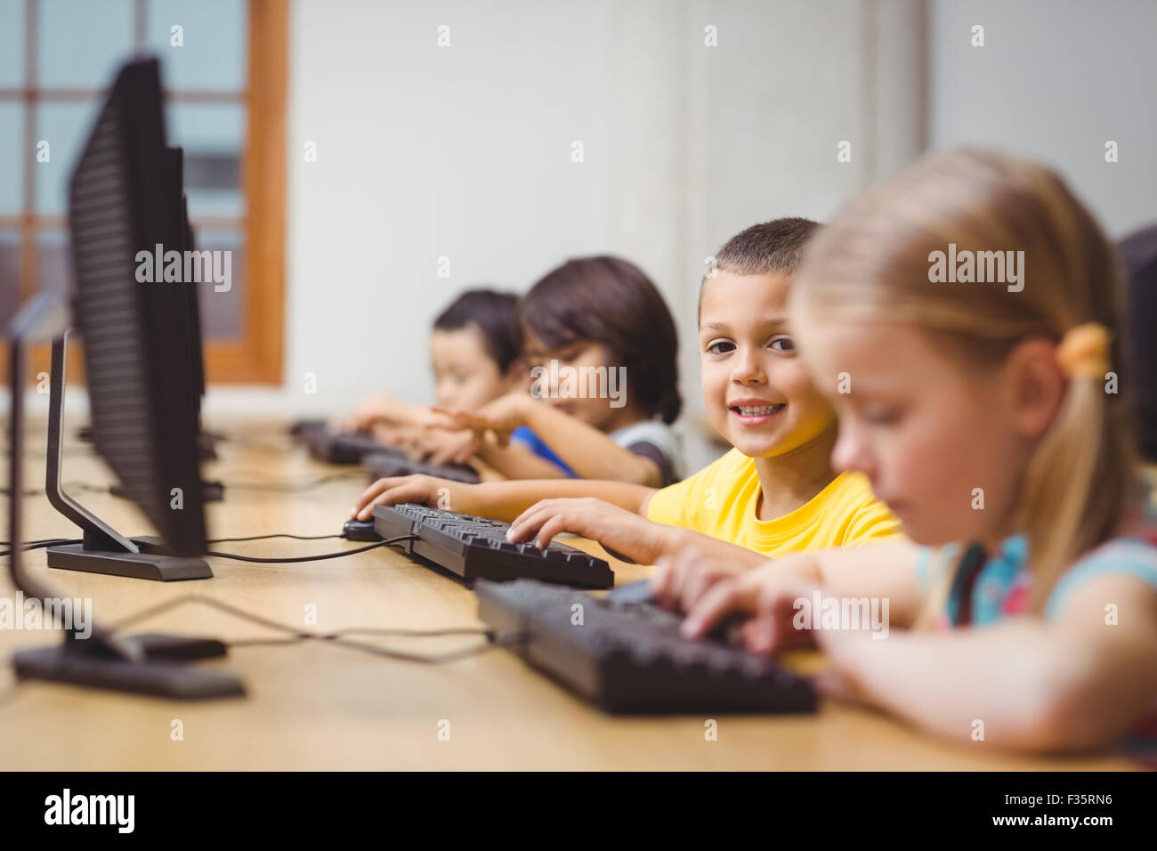 Cute pupils in computer class Stock Photo - Alamy