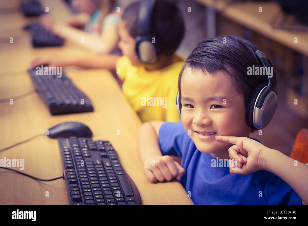 Cute pupils in computer class Stock Photo - Alamy