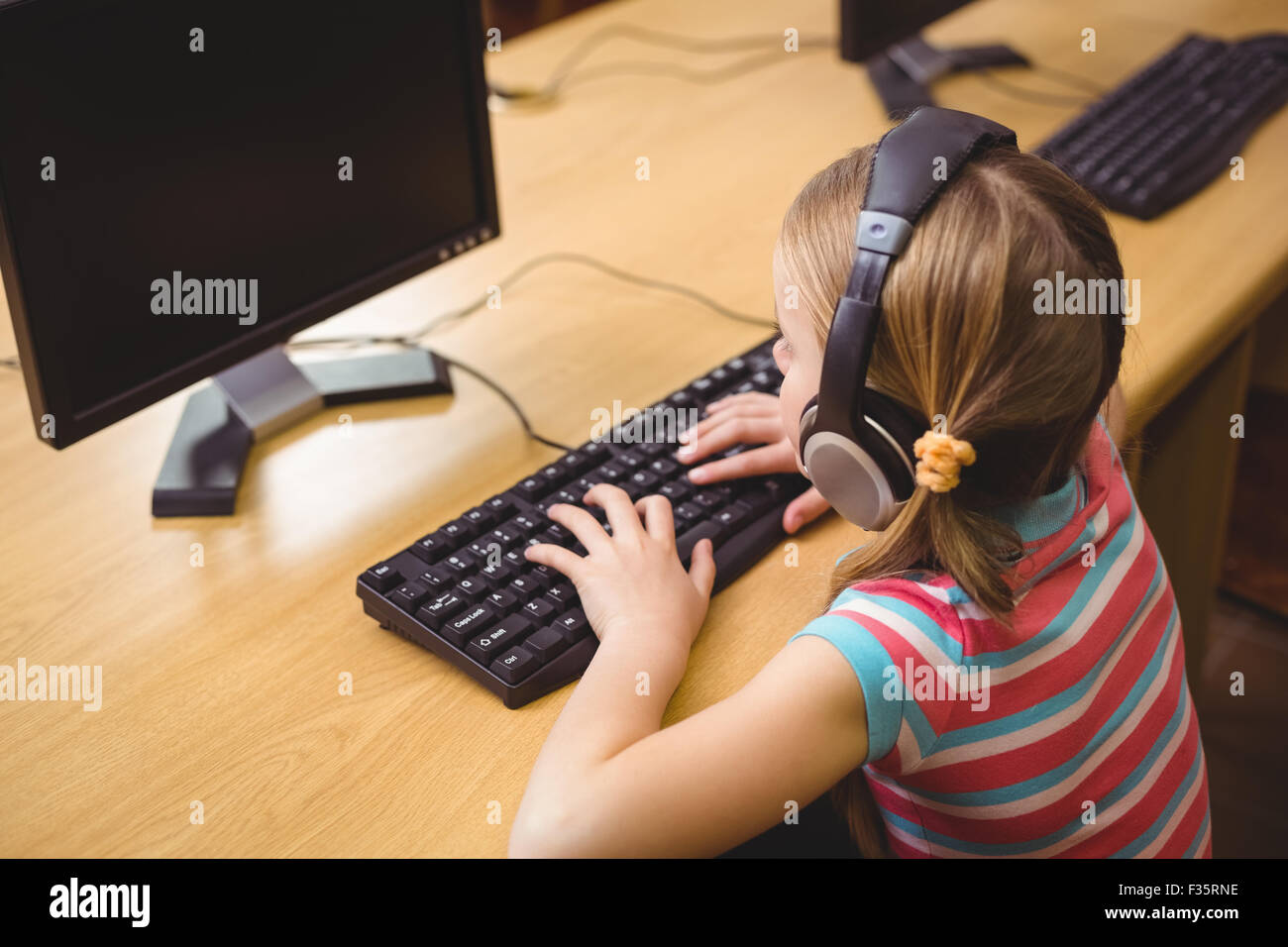 Cute pupil in computer class Stock Photo - Alamy