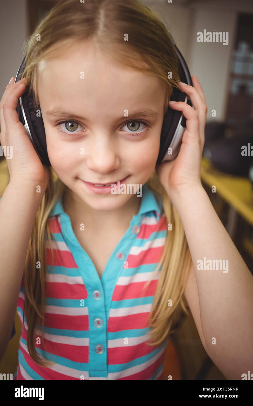 Cute pupil in computer class smiling at camera Stock Photo - Alamy