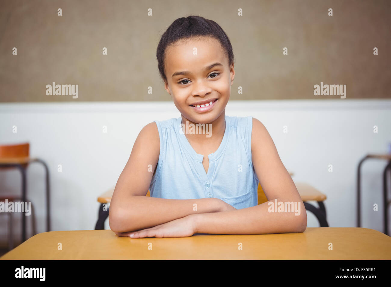 Smiling student sitting at a desk Stock Photo - Alamy